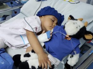 Post-Operative Child Hugging Stuffed Cow - Capitol City Medical Teams